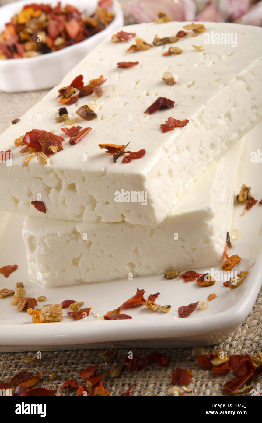 goat cheese with cracked chili peppers Stock Photo - Alamy