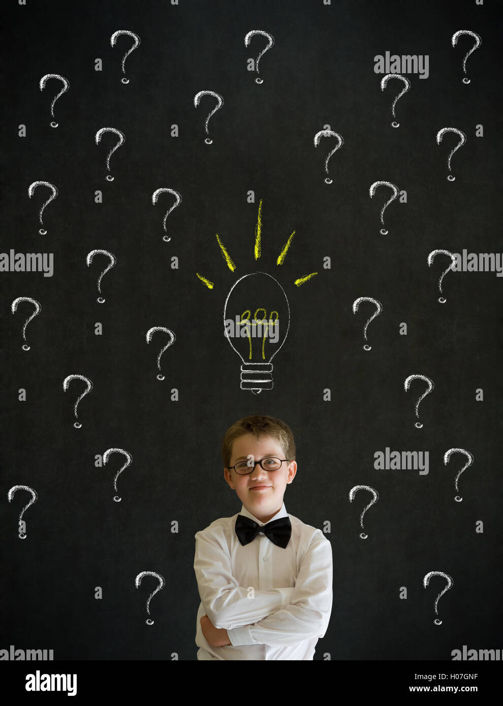 Thinking boy dressed up as business man questioning ideas Stock Photo ...