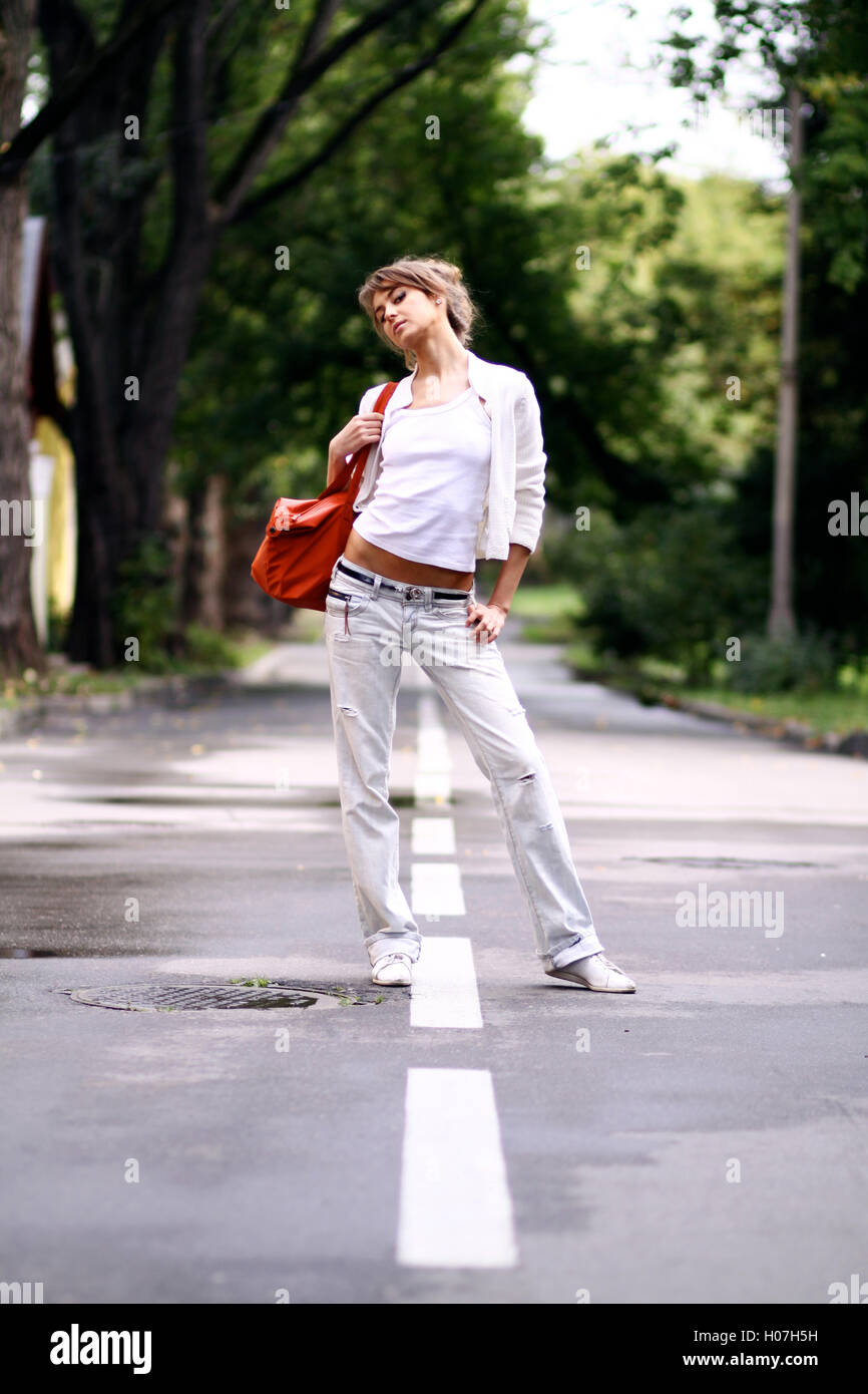 Full length, walking woman in blue jeans Stock Photo - Alamy