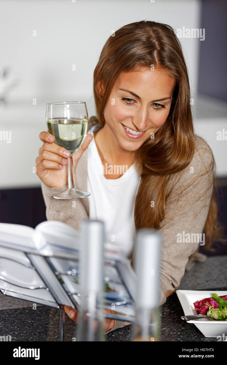 Woman reading a recipe book Stock Photo - Alamy