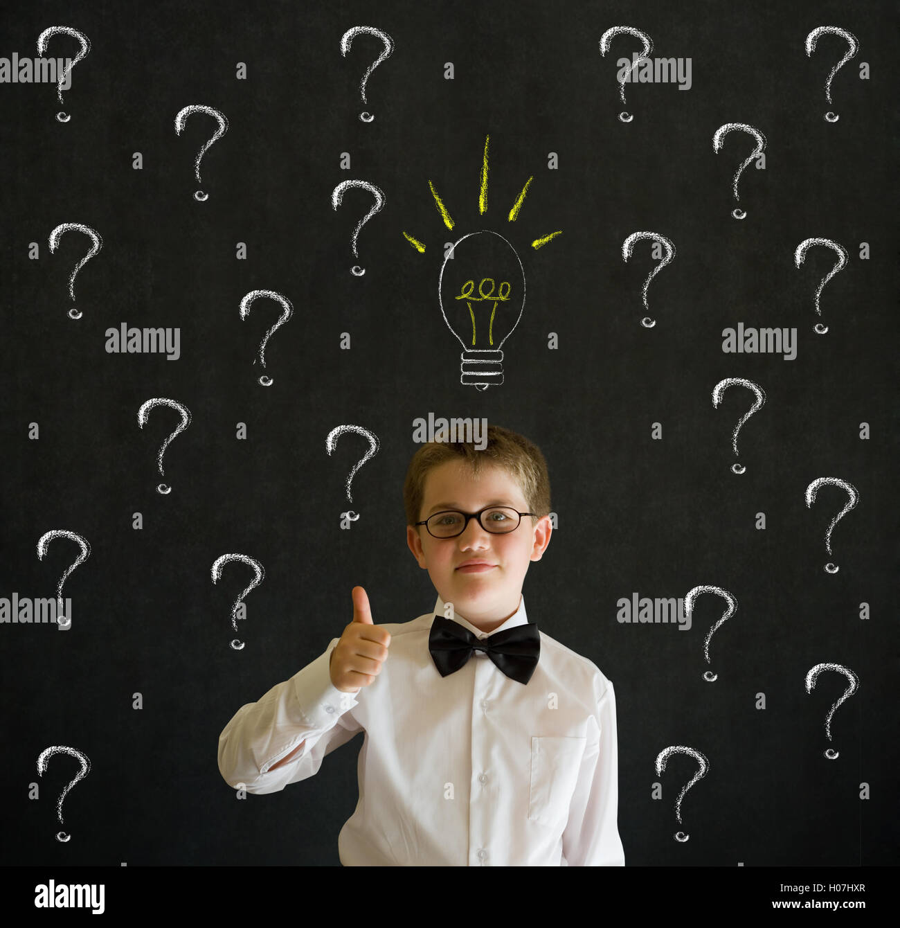 Thumbs up boy dressed up as business man questioning ideas Stock Photo ...