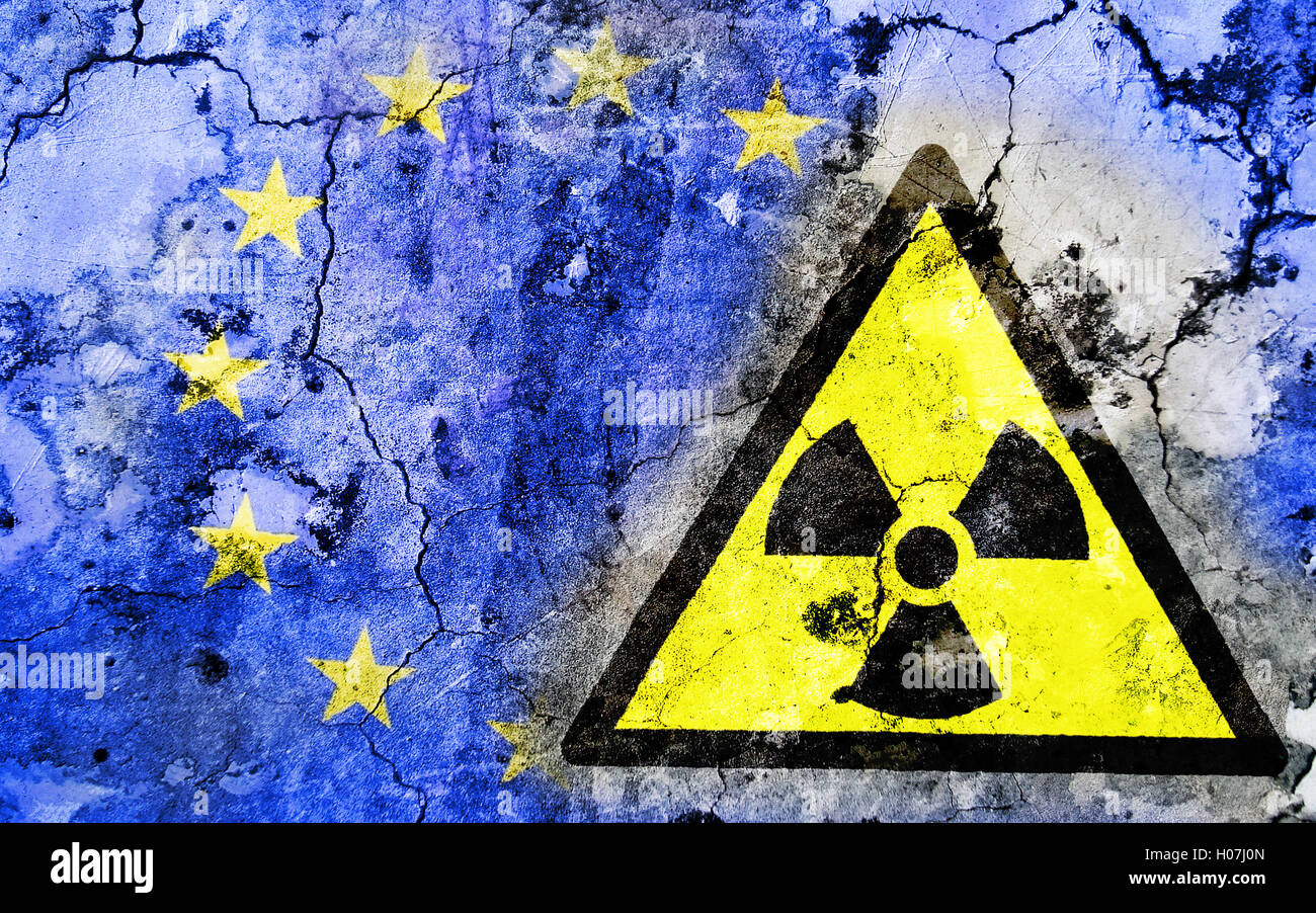 Old cracked wall with radiation warning sign and painted flag Stock ...