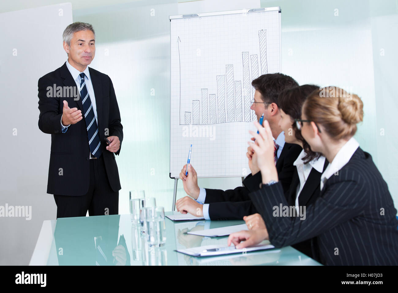 Manager giving a presentation to staff Stock Photo - Alamy