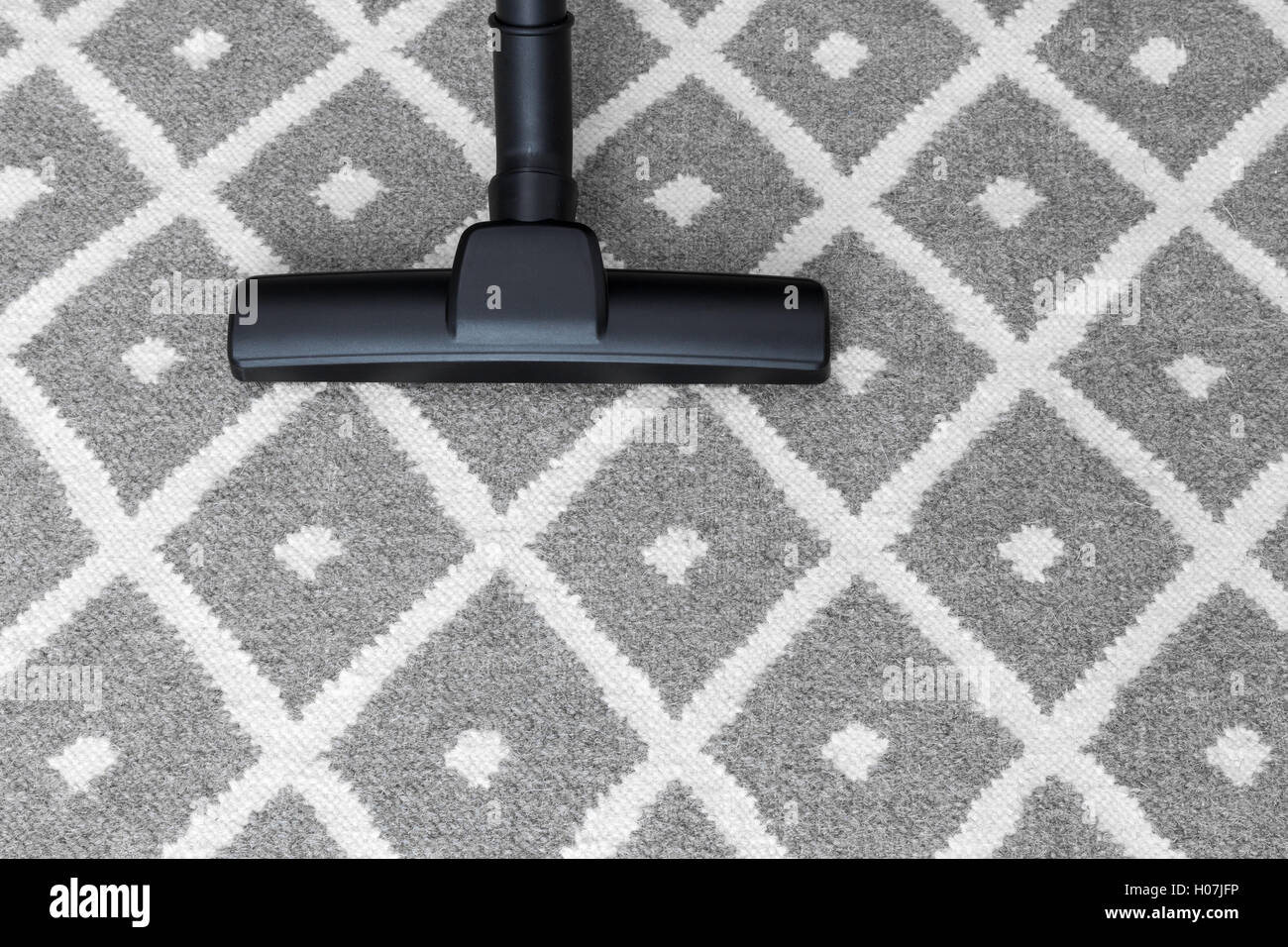Vacuum cleaner on gray carpet Stock Photo - Alamy