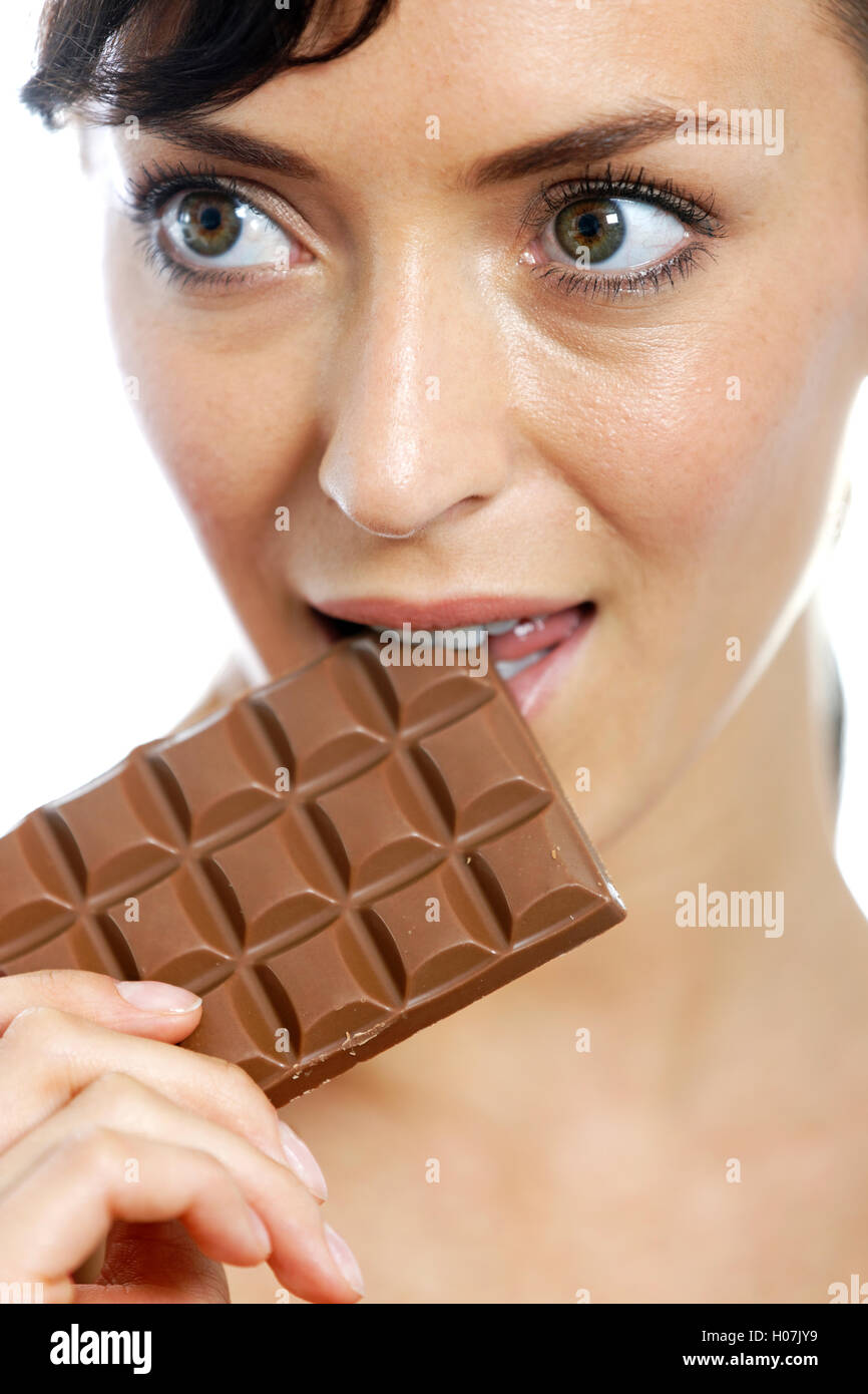 Woman eating chocolate bar Stock Photo - Alamy