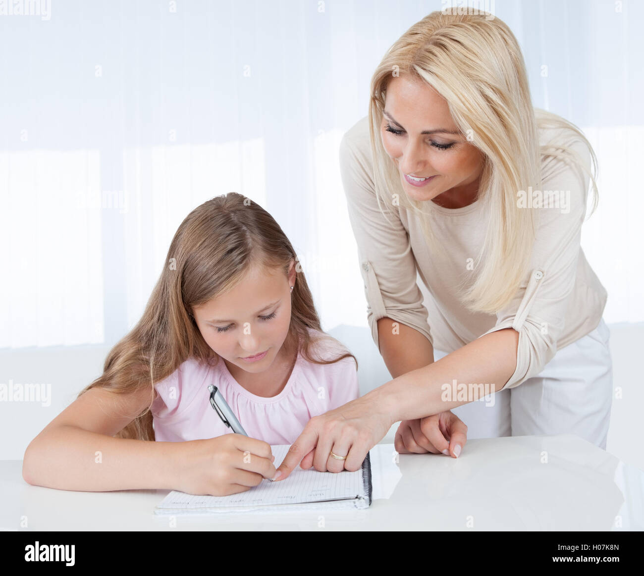 Mother Helping Her Daughter With Homework Stock Photo - Alamy