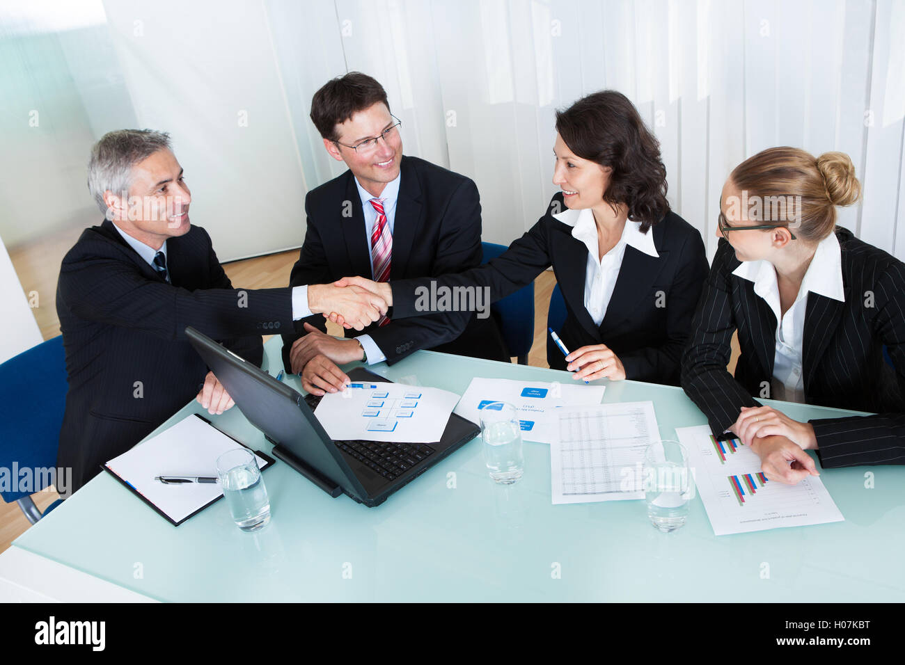 Colleagues congratulating one another Stock Photo - Alamy