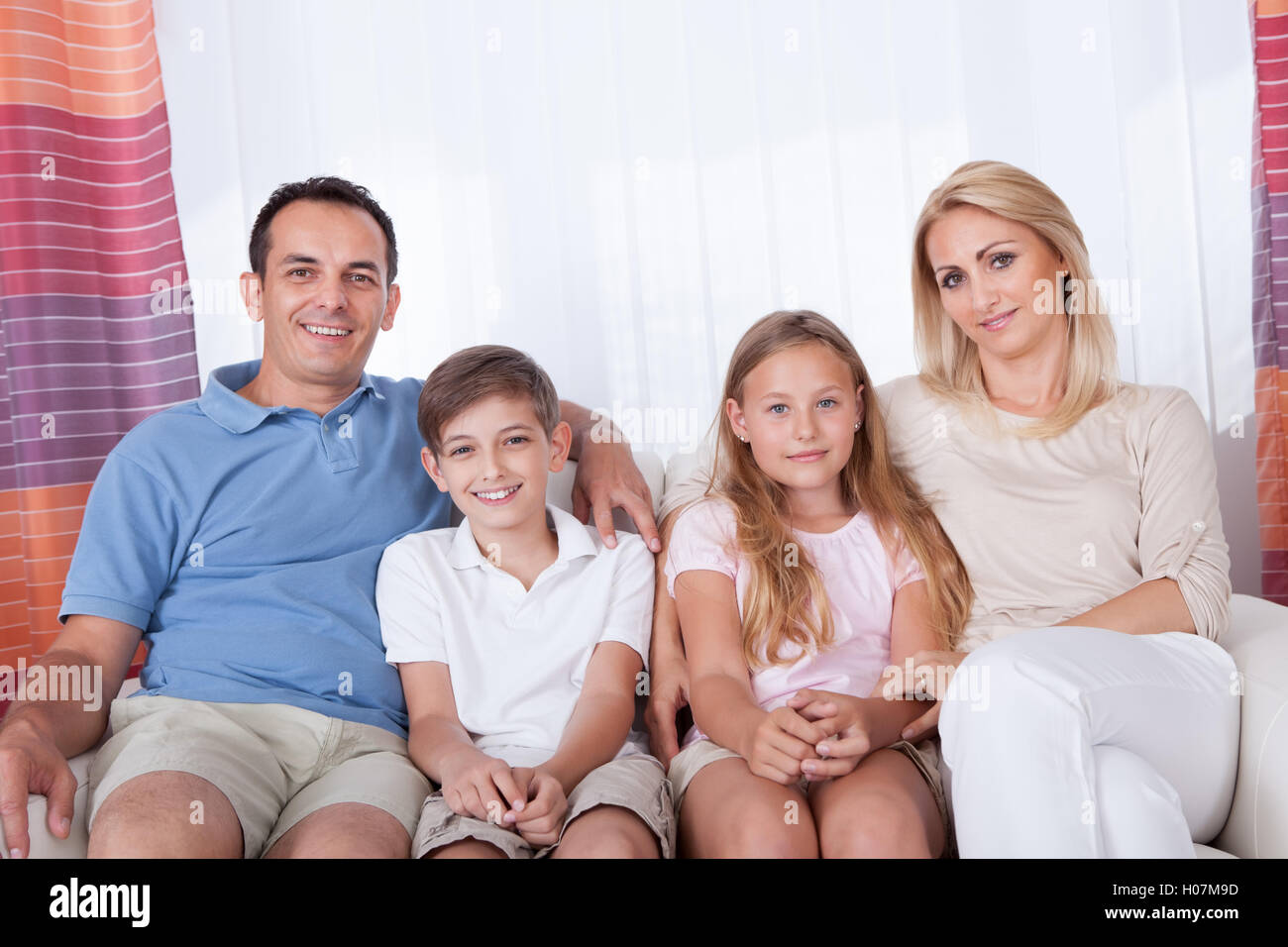 A Happy Family With Two Children Stock Photo - Alamy