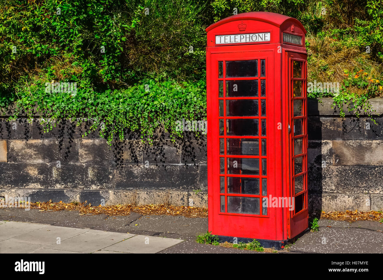 Typical red English telephone booth in the park Stock Photo - Alamy