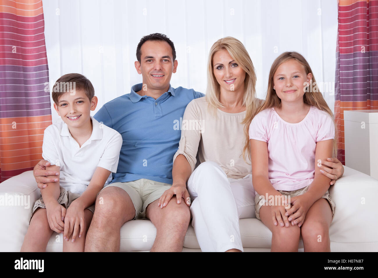 A Happy Family With Two Children Stock Photo - Alamy