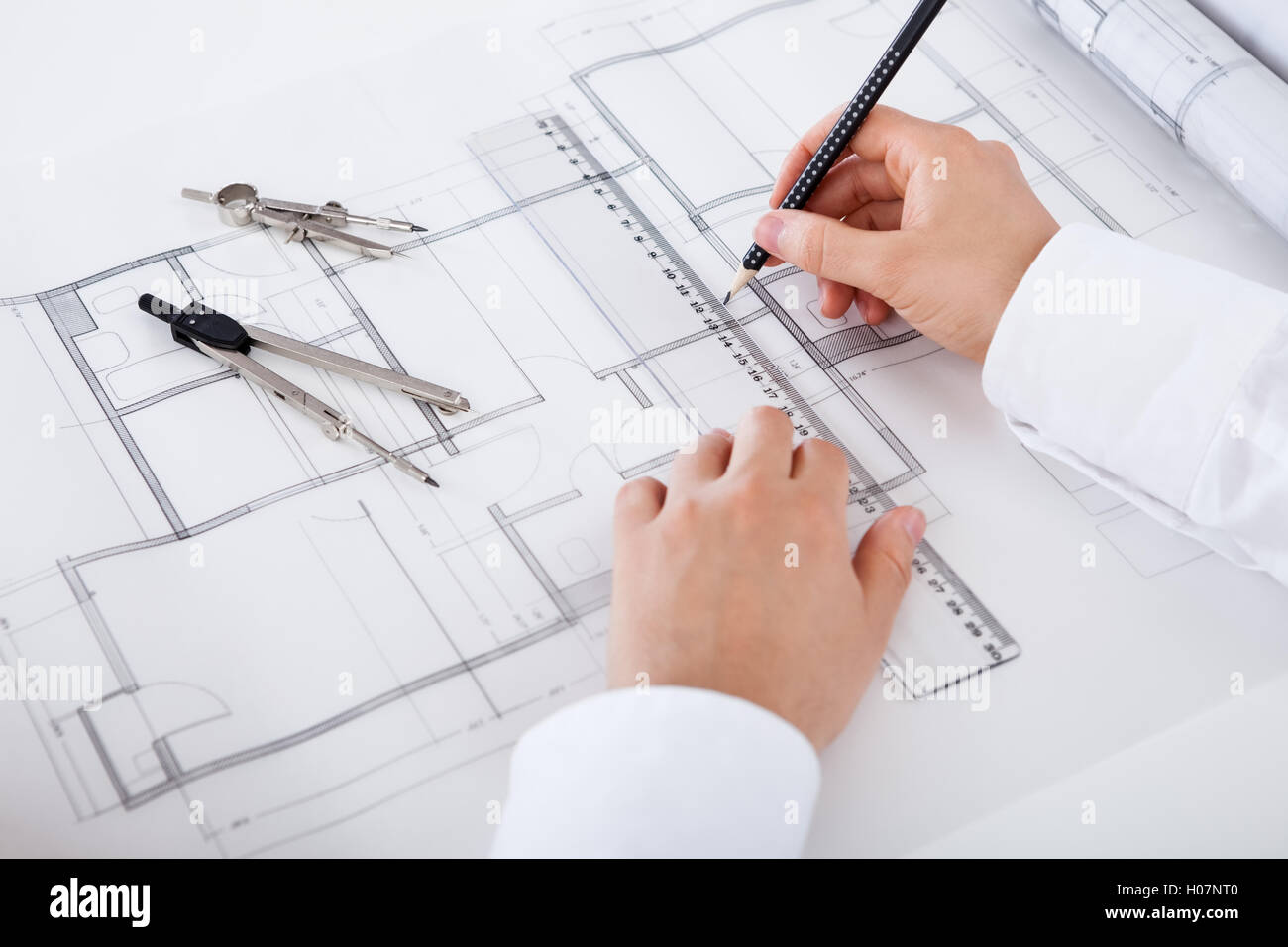Architect working on blueprints Stock Photo - Alamy