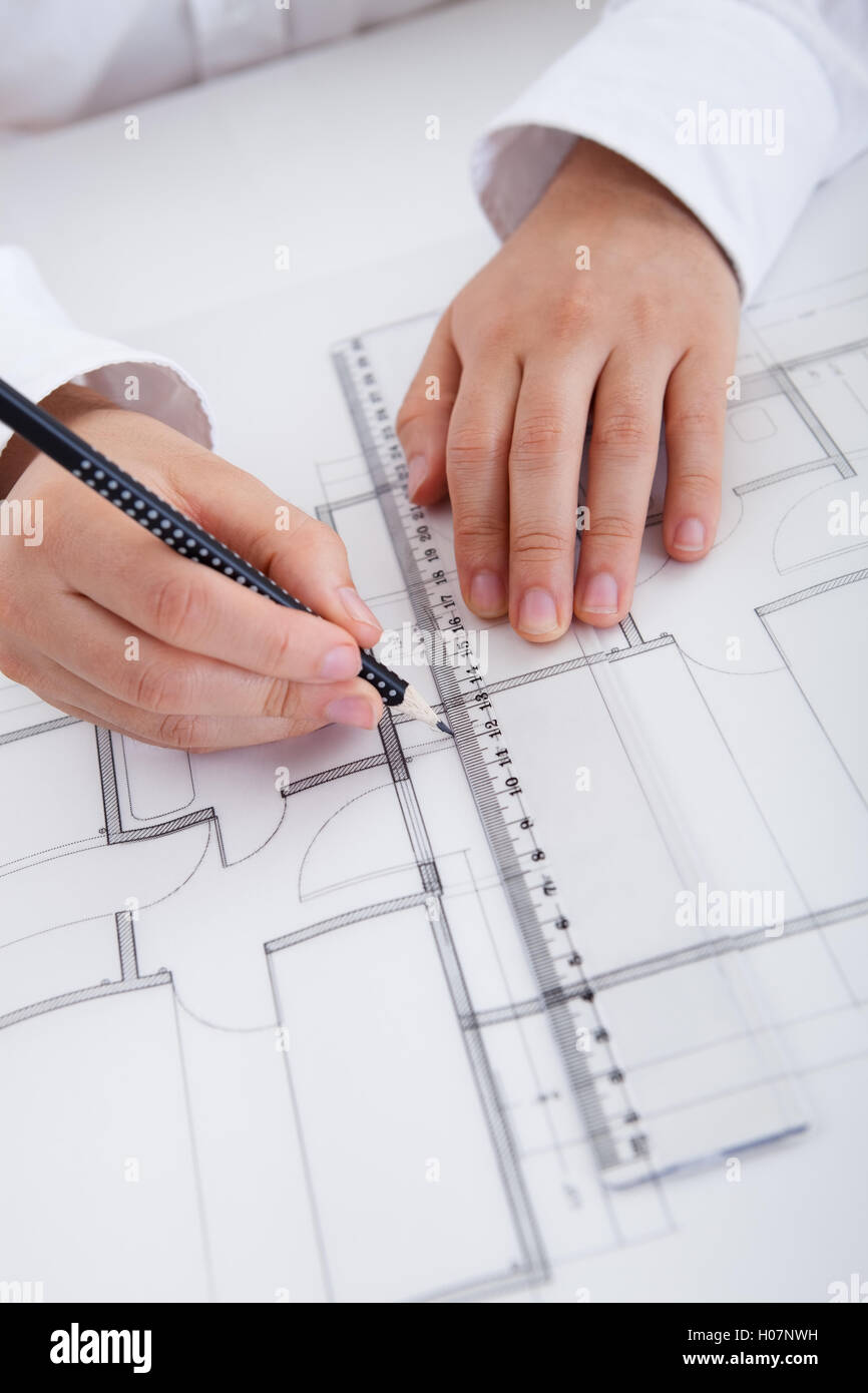 Architect working on blueprints Stock Photo - Alamy