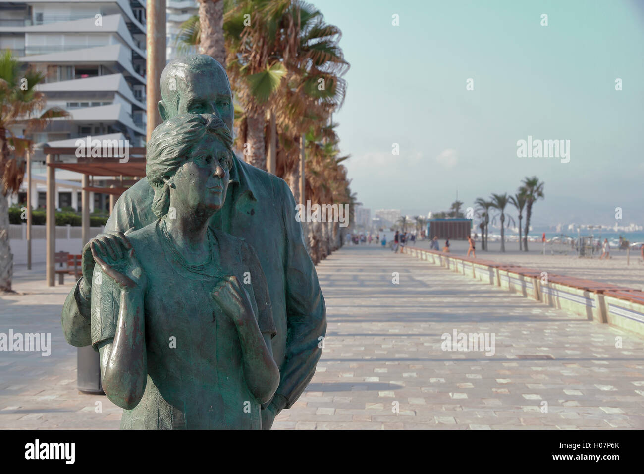 foreground of a bronze statue of two elderly looking into infinity ...