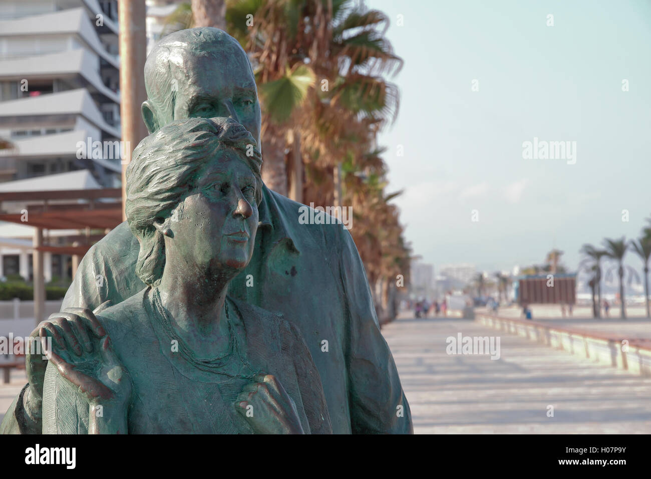 foreground of a bronze statue of two elderly looking into infinity ...
