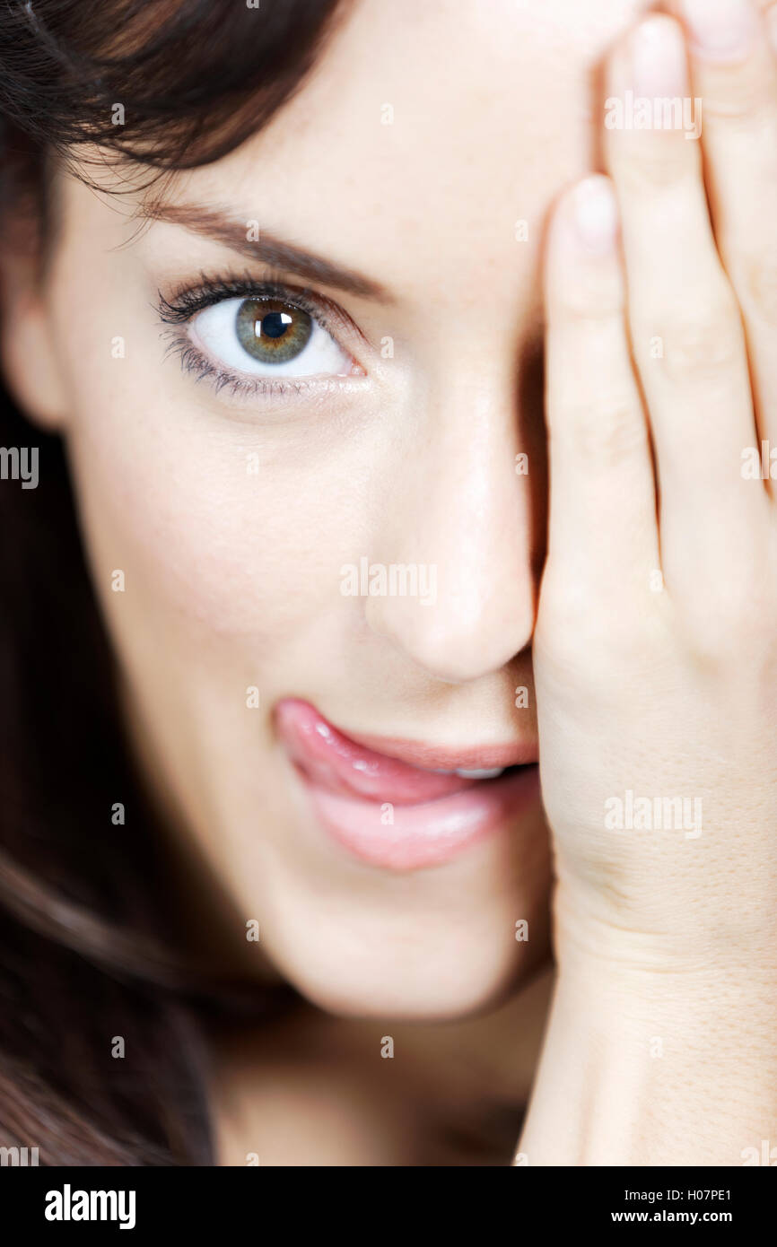 Woman covering half of face Stock Photo - Alamy