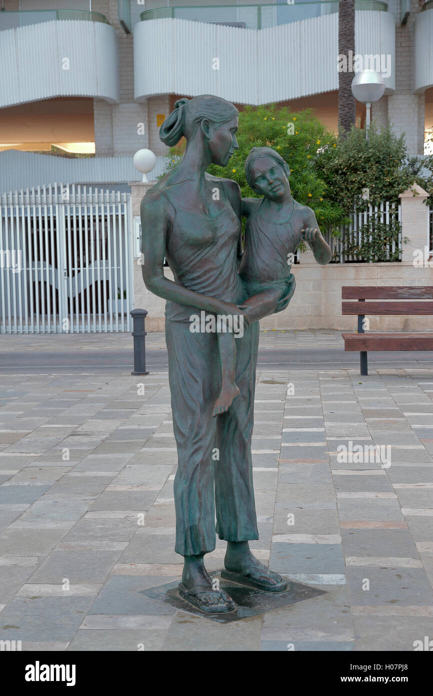 bronze statue of a mother taking her daughter in arms Stock Photo - Alamy