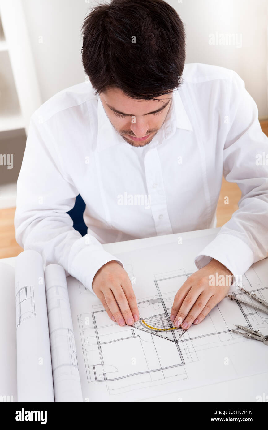 Architect working on blueprints Stock Photo - Alamy