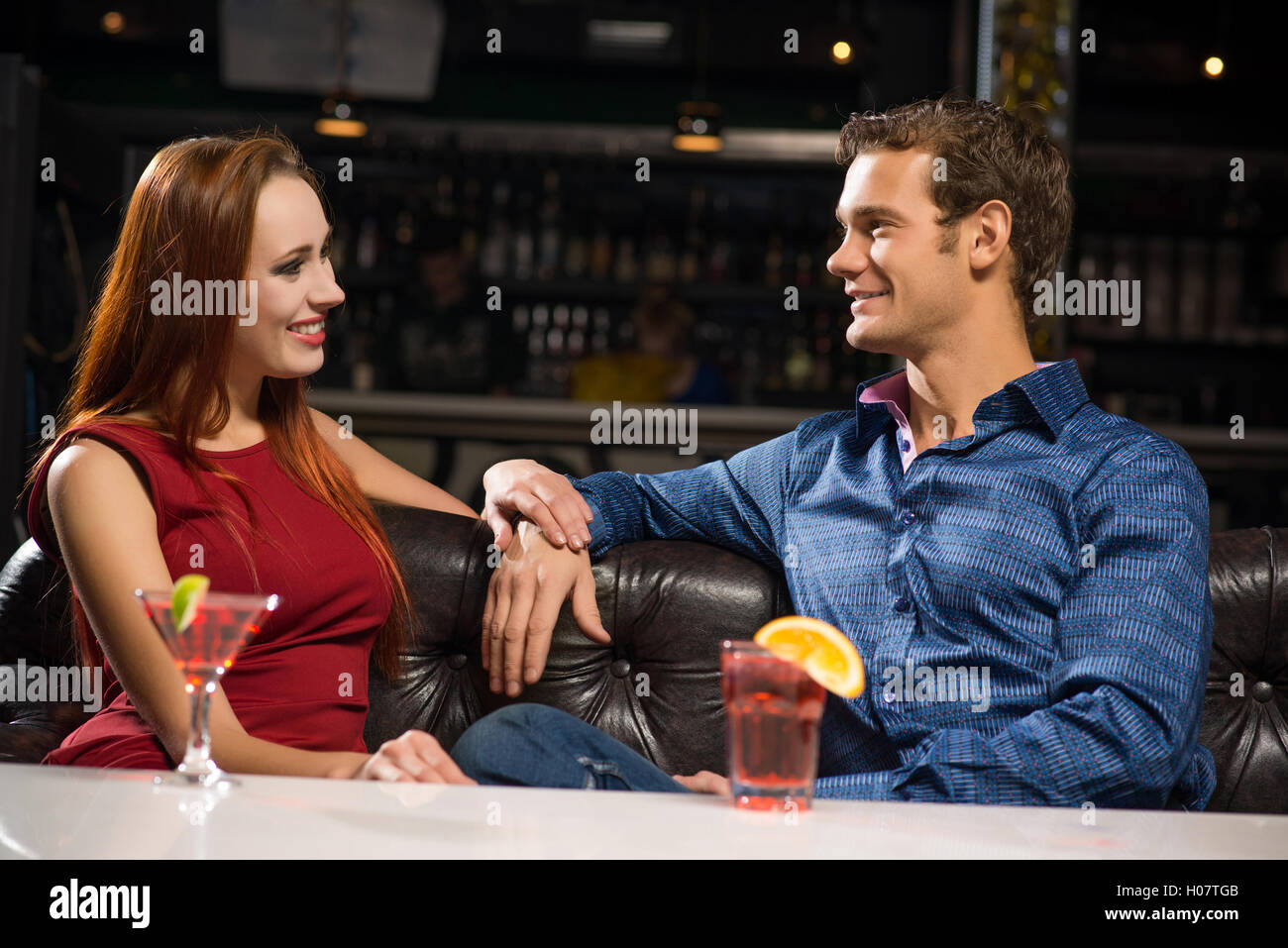 Young couple talking in a nightclub Stock Photo - Alamy