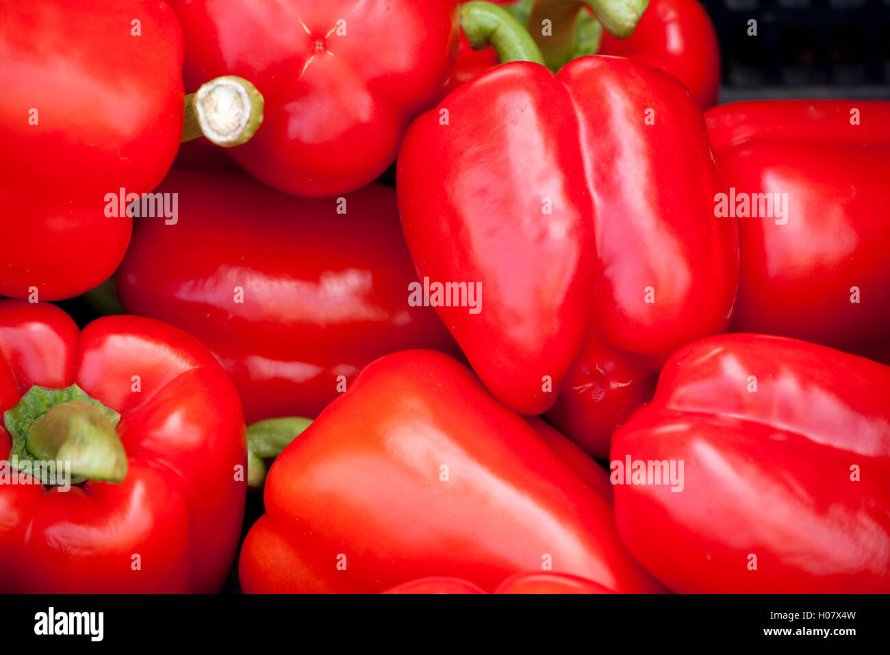 Group of fresh red peppers on a store Stock Photo - Alamy