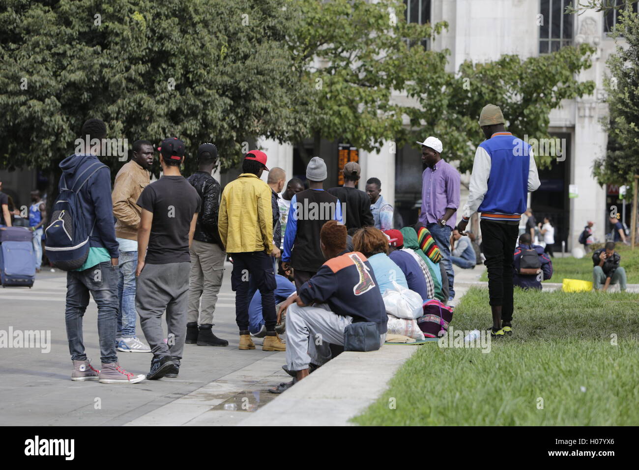 Rome, Italy. 18th Sep, 2016. Refugees sit in a small park in front of ...