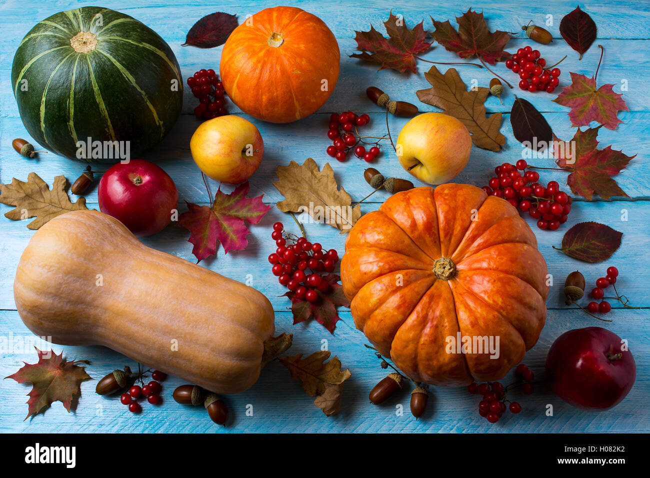 Autumn seasonal vegetables and fruits on the blue wooden background ...