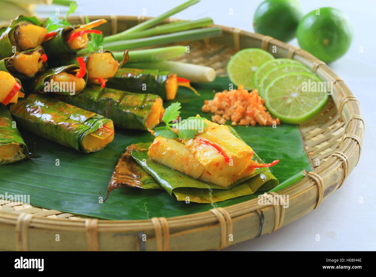 Vietnamese steamed rice pancake with shrimp on tray with banana leaf ...