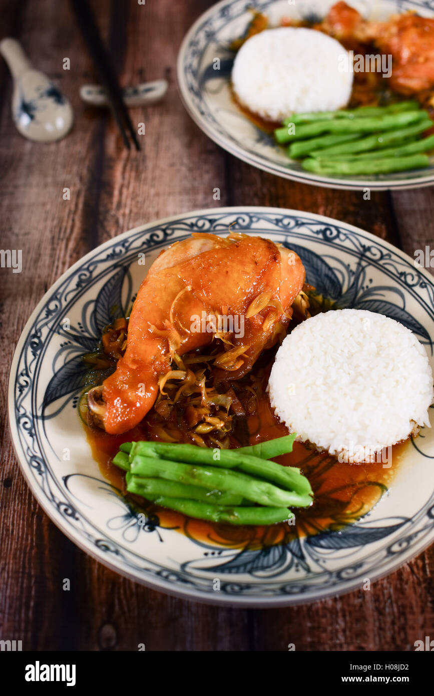 Vietnamese rice with fried chicken legs and green beans on the table ...