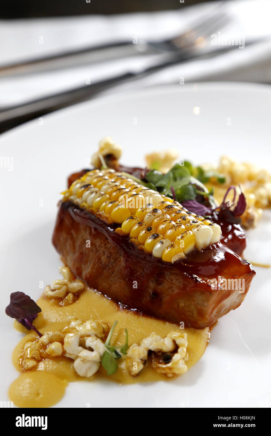 Fried beef with roasted corn on white plate Stock Photo - Alamy