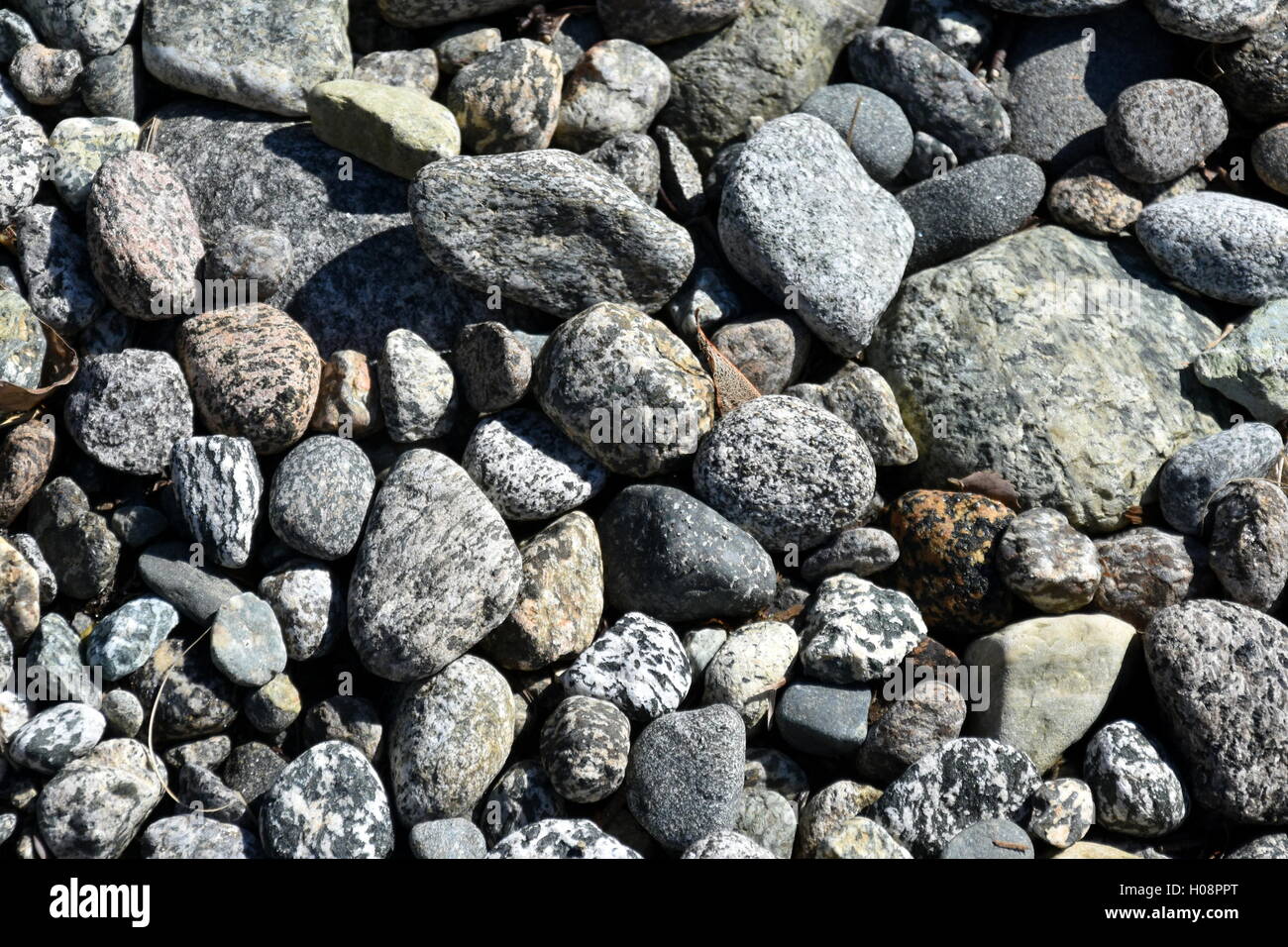 Natural wet rocks in river water background Stock Photo - Alamy