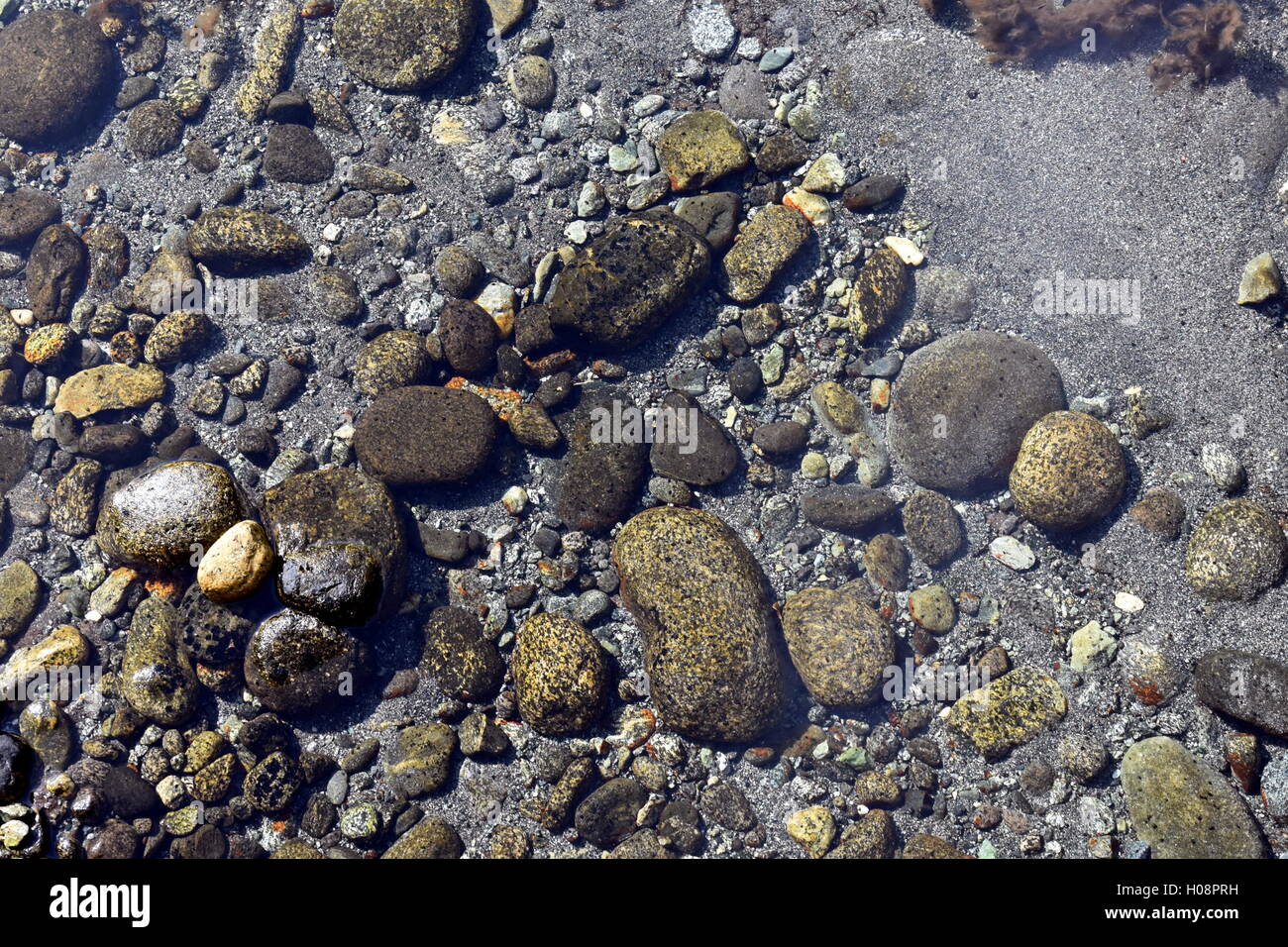 Natural wet rocks in river water background Stock Photo - Alamy