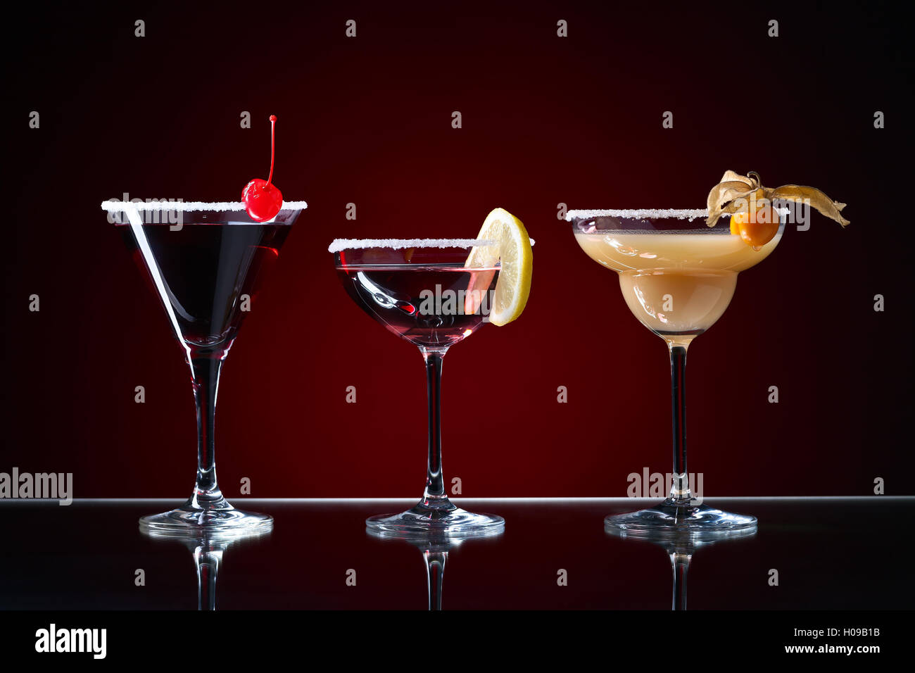 Different cocktails with fruits on a red background Stock Photo - Alamy