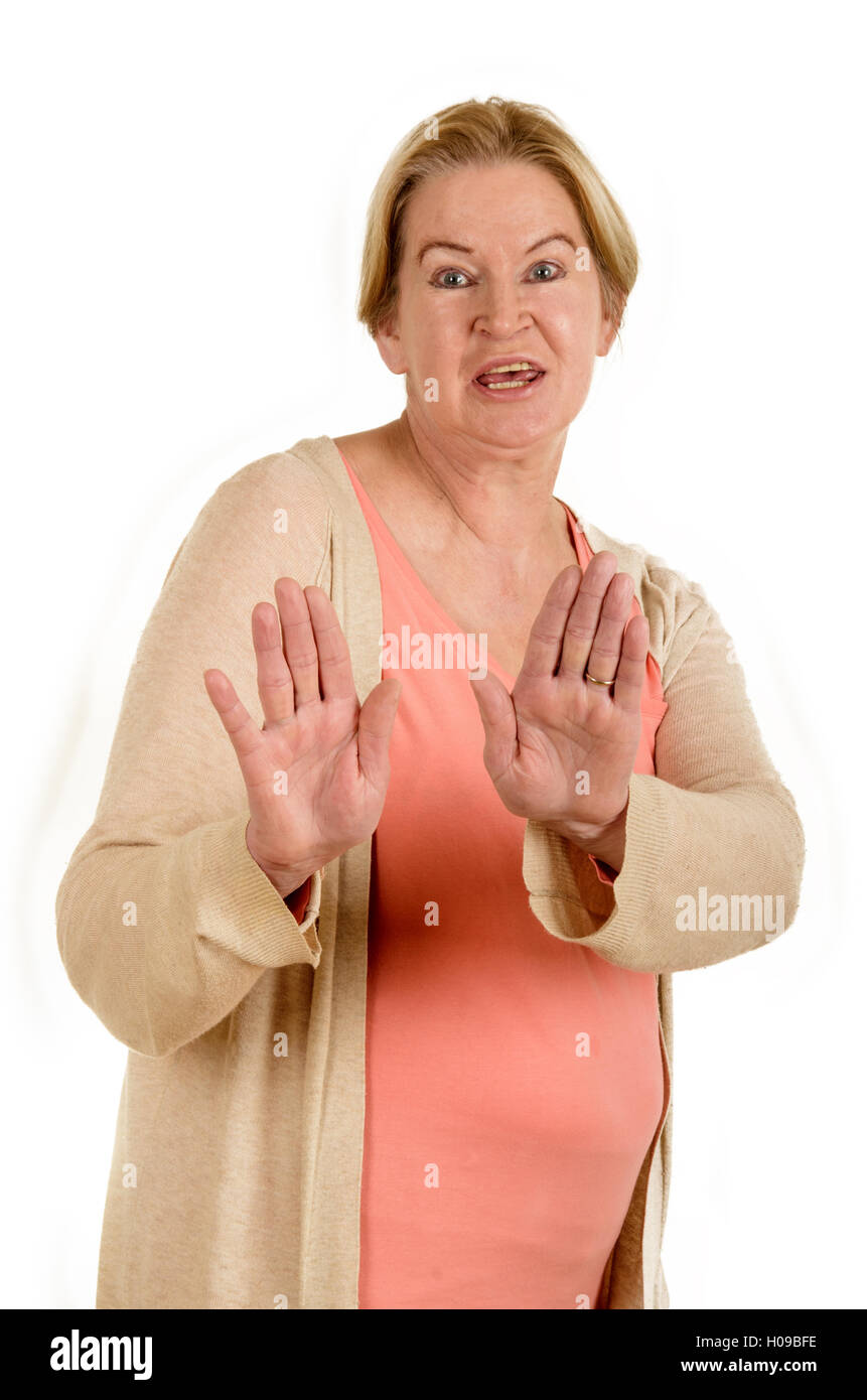 blonde woman with raised hands in a defensive pose, isolated on white ...