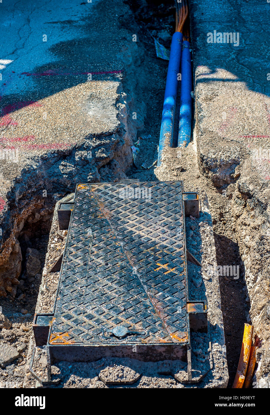 fiber optic cables buried in a micro trench with concrete colored red ...