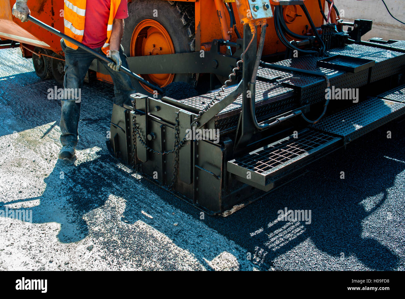 Industrial truck laying fresh bitumen hi-res stock photography and ...