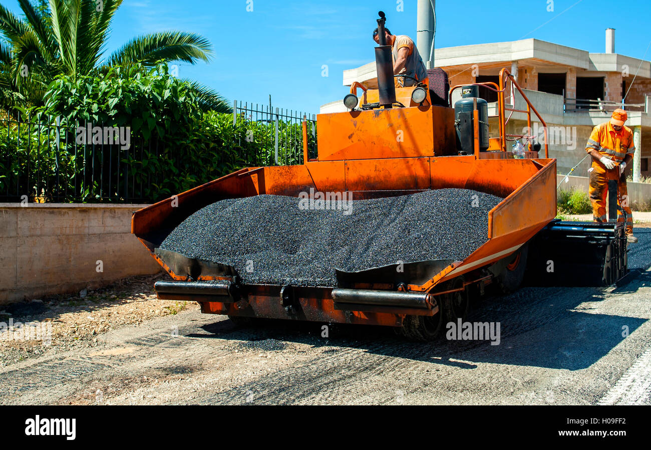 industrial truck laying fresh bitumen and asphalt at road construction ...
