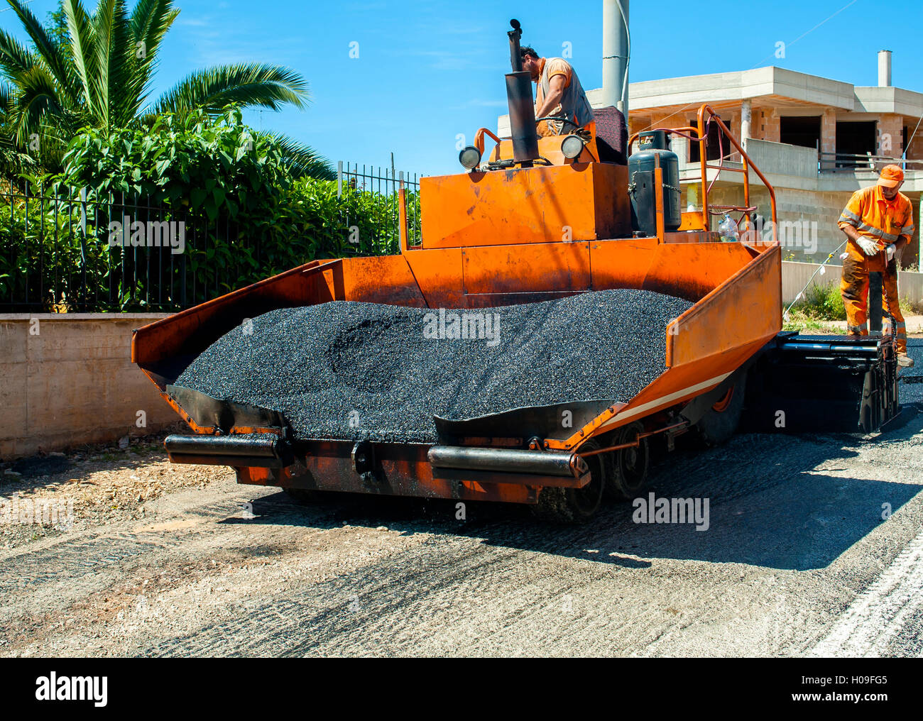 industrial truck laying fresh bitumen and asphalt at road construction ...