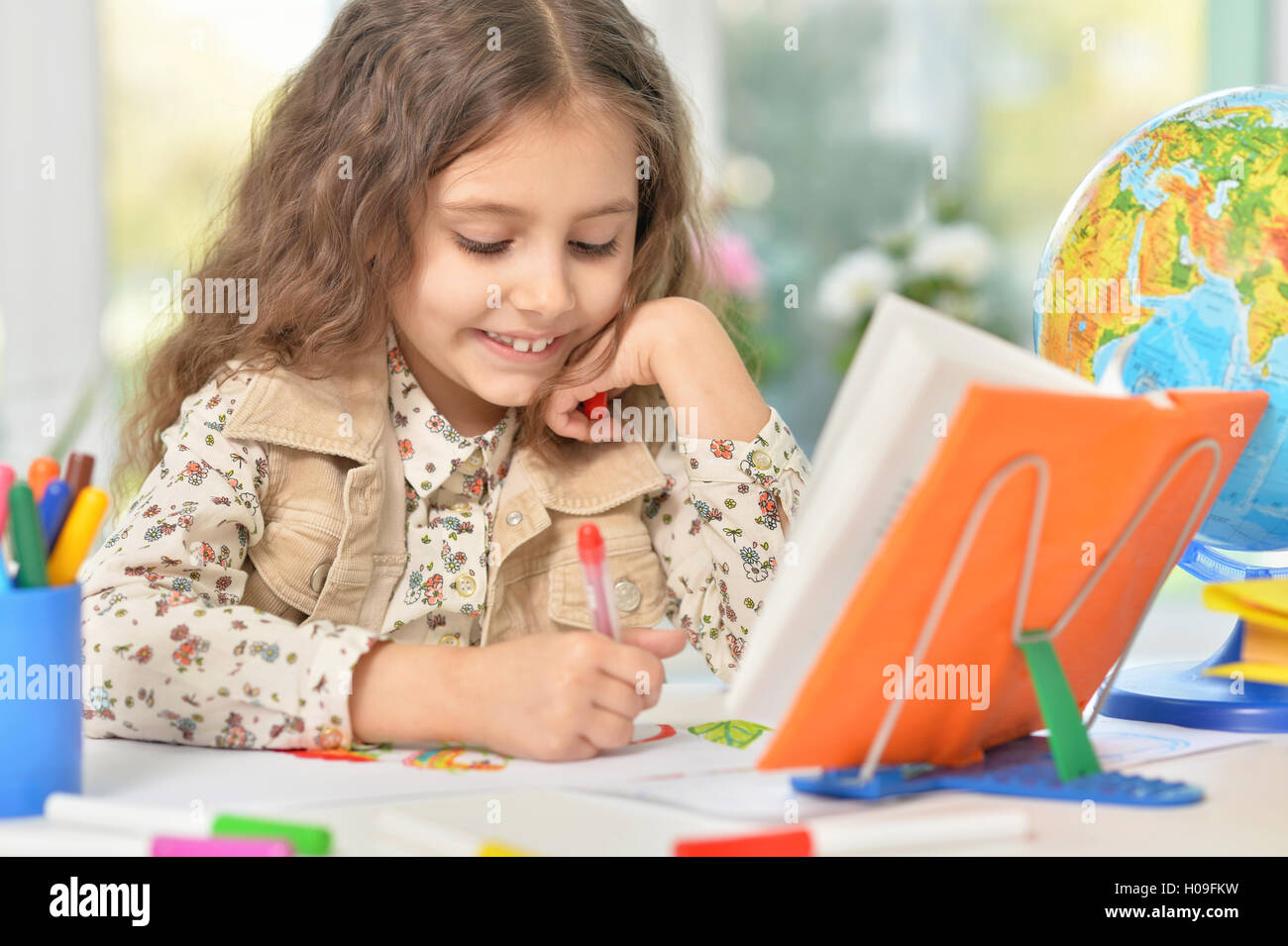 Little girl drawing at class Stock Photo - Alamy