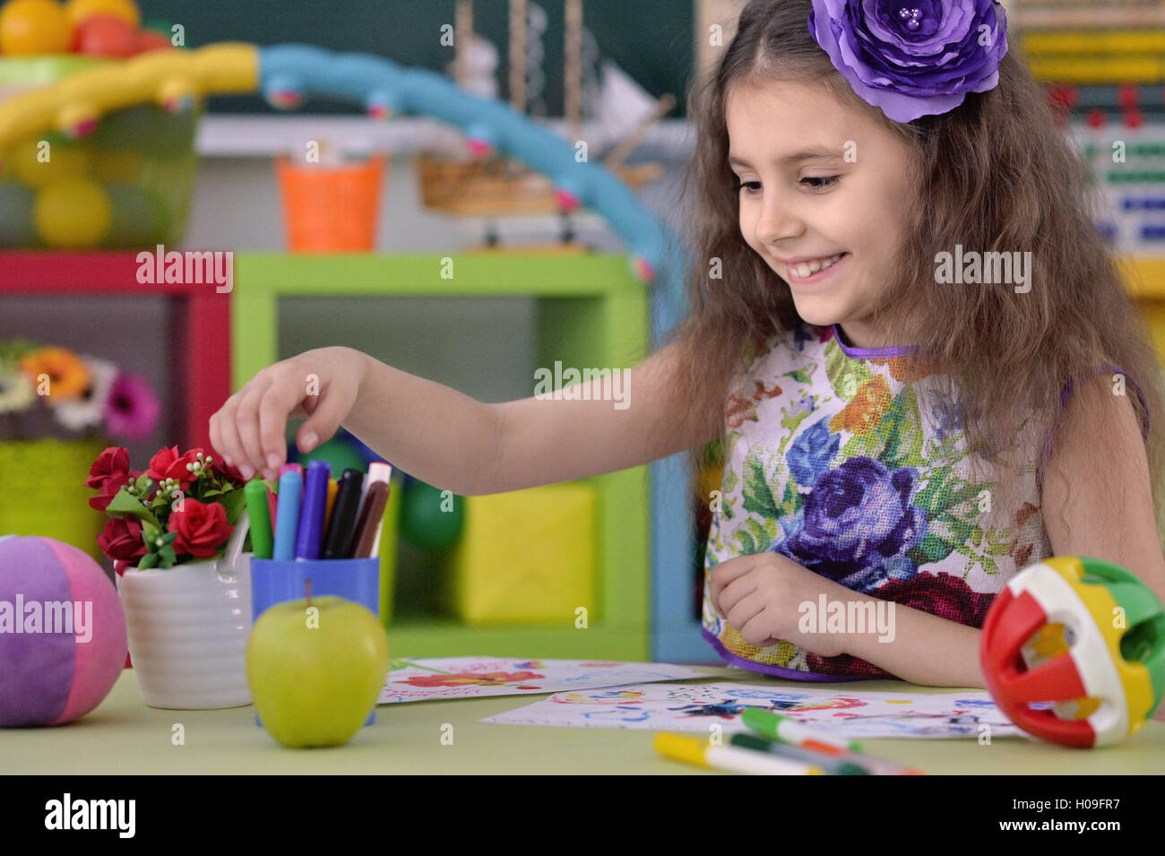 Little girl drawing at class Stock Photo - Alamy