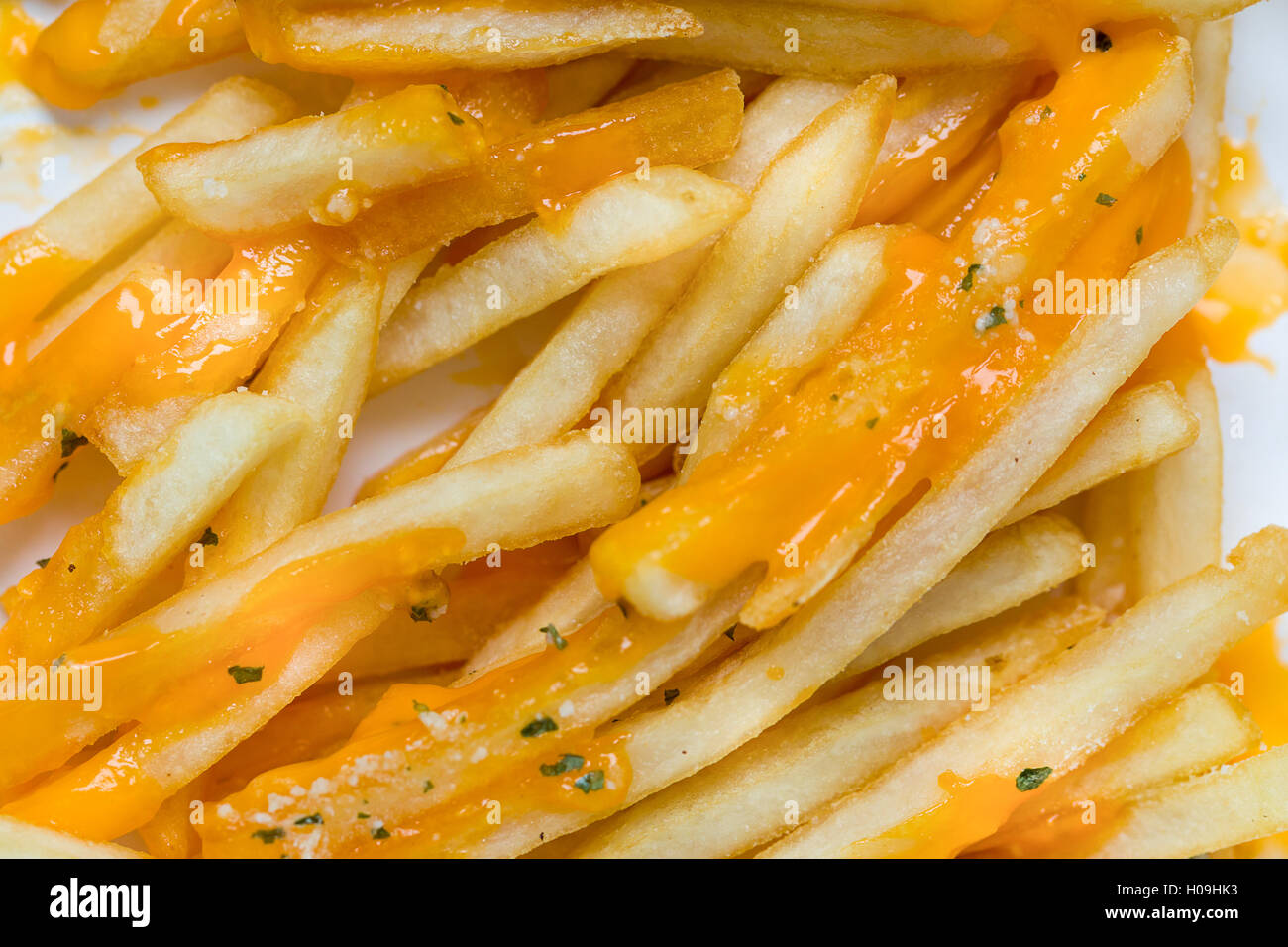 French fried with melted cheddar cheese background Stock Photo - Alamy