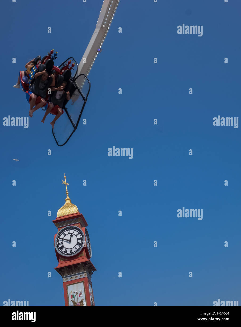 fairground ride passing weymouth clock tower Stock Photo - Alamy