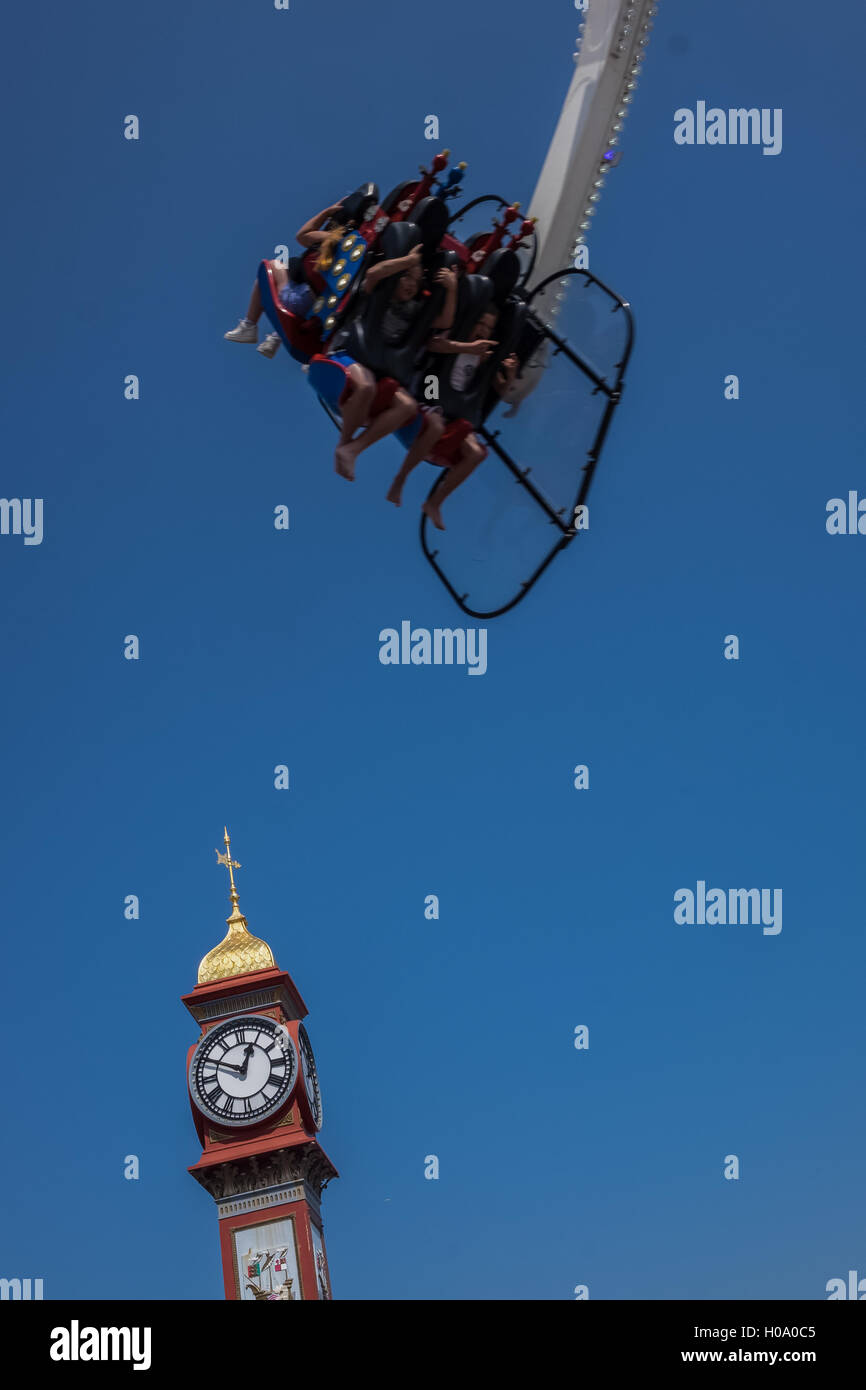 fairground ride passing weymouth clock tower Stock Photo - Alamy