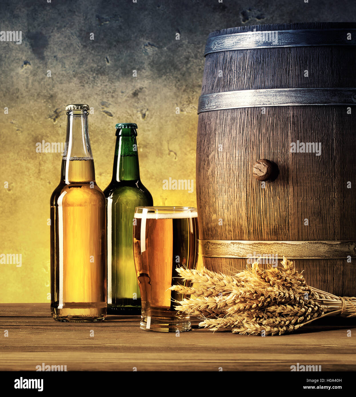 Still life with bottles and glass of beer stained in yellow blue Stock ...