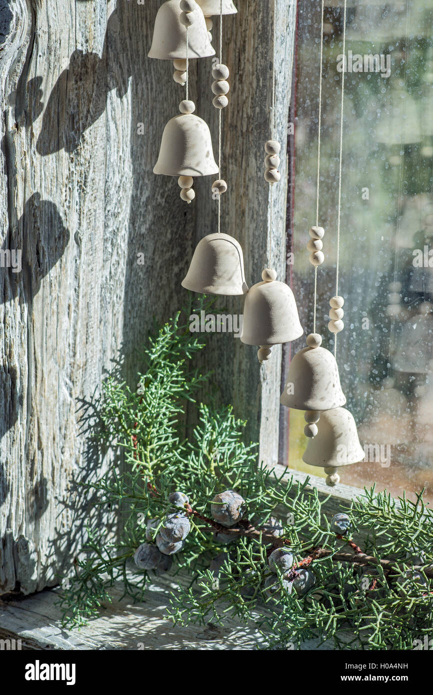 Christmas bells hanging in front of an old window Stock Photo - Alamy