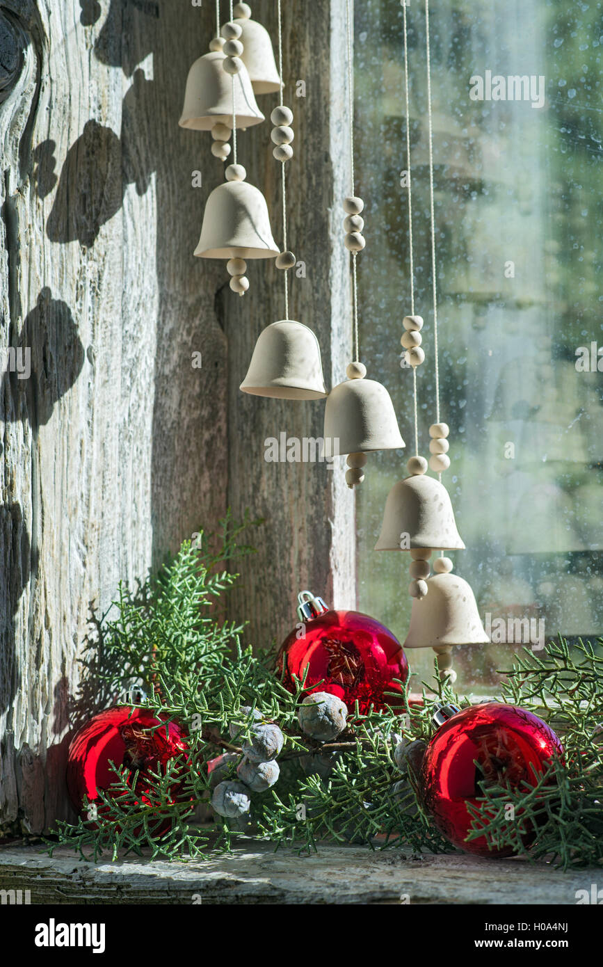 Christmas bells hanging in front of an old window Stock Photo - Alamy