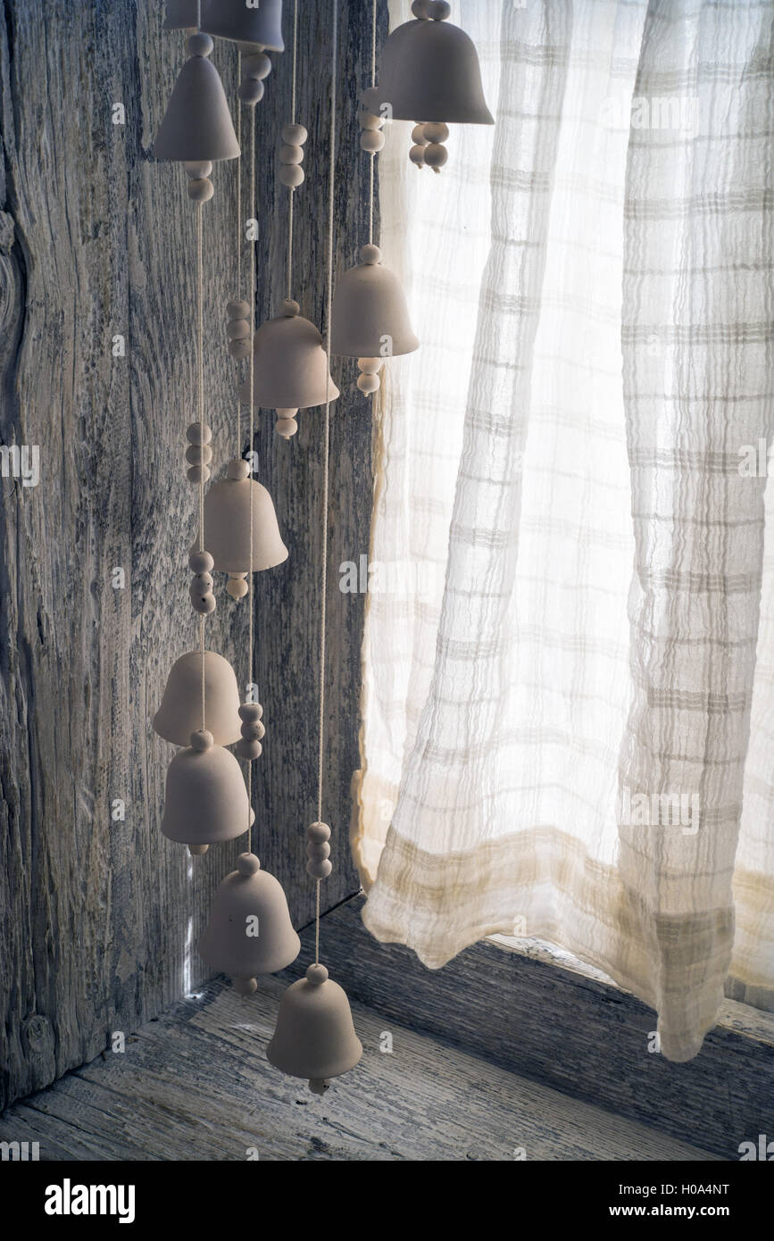 Christmas bells hanging in front of an old window Stock Photo - Alamy