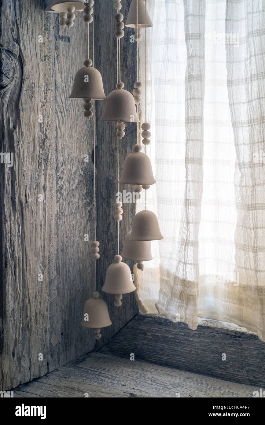 Christmas bells hanging in front of an old window Stock Photo - Alamy