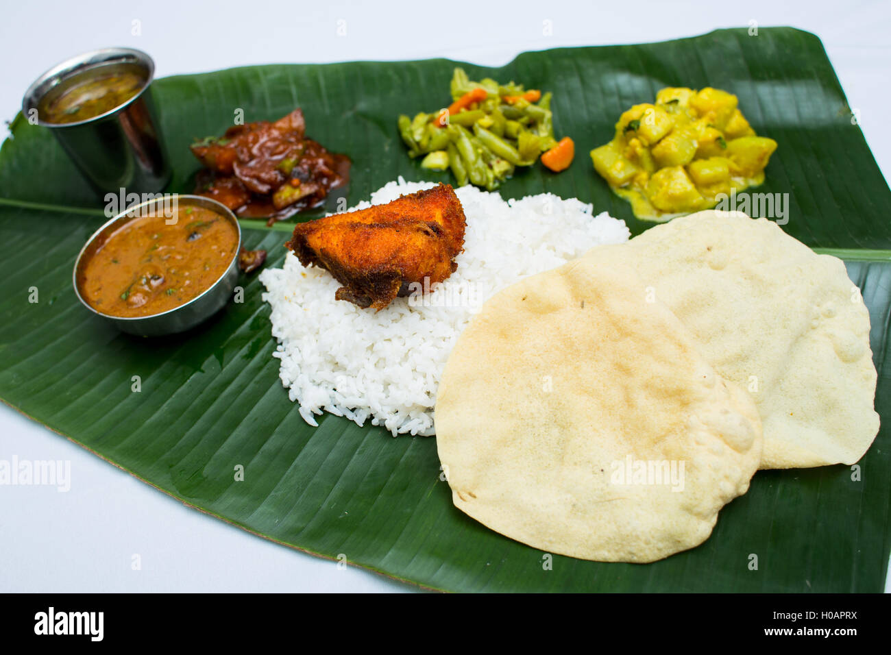 Indian meal with fish and plain rice on banana leaf tray Stock Photo ...