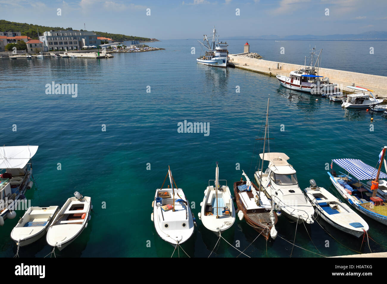 Postira harbor view to the North with some boats in foreground picture ...