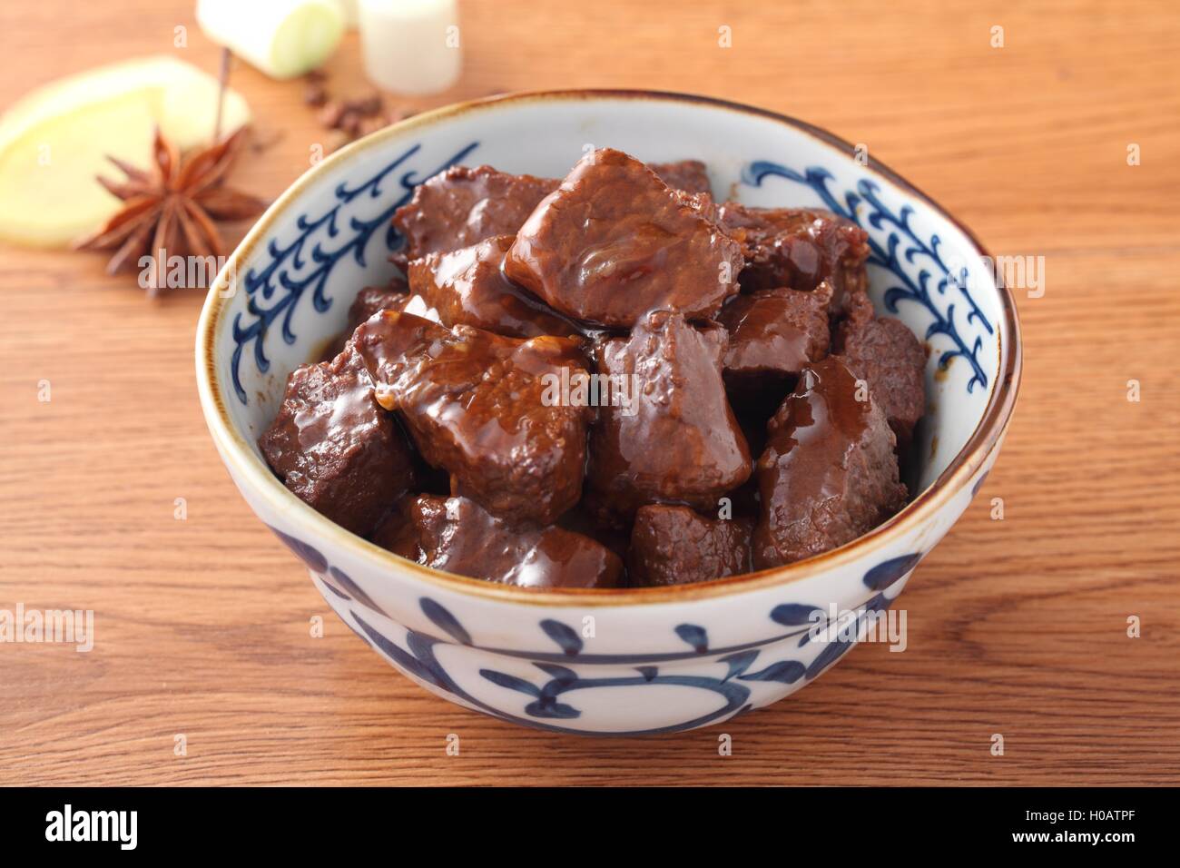 Bowl of fried pork on wooden table in restaurant Stock Photo - Alamy