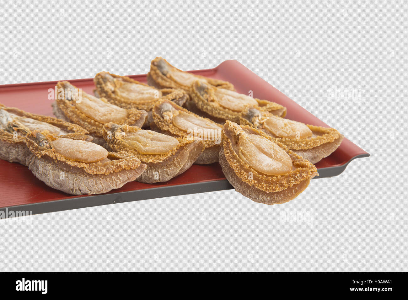 Dried abalone on bamboo tray in white background Stock Photo - Alamy